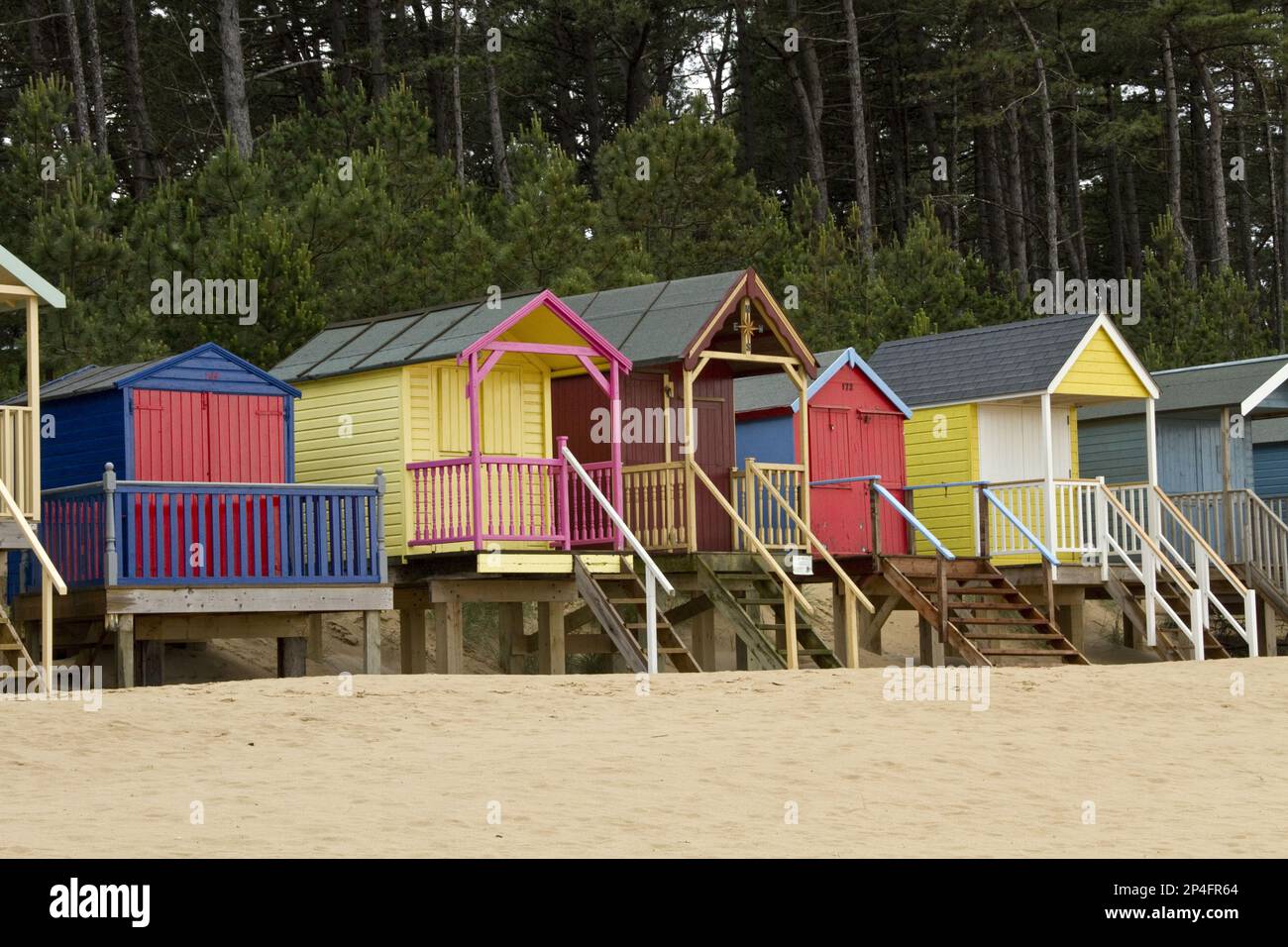 Colourfully painted beach huts at Holkham Bay near Wells by the Sea ...