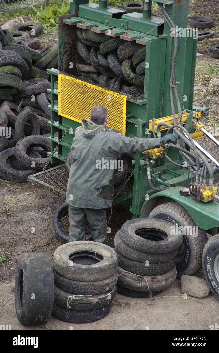 Recycling rubber tyres, compressing tyres into bale with wire ...