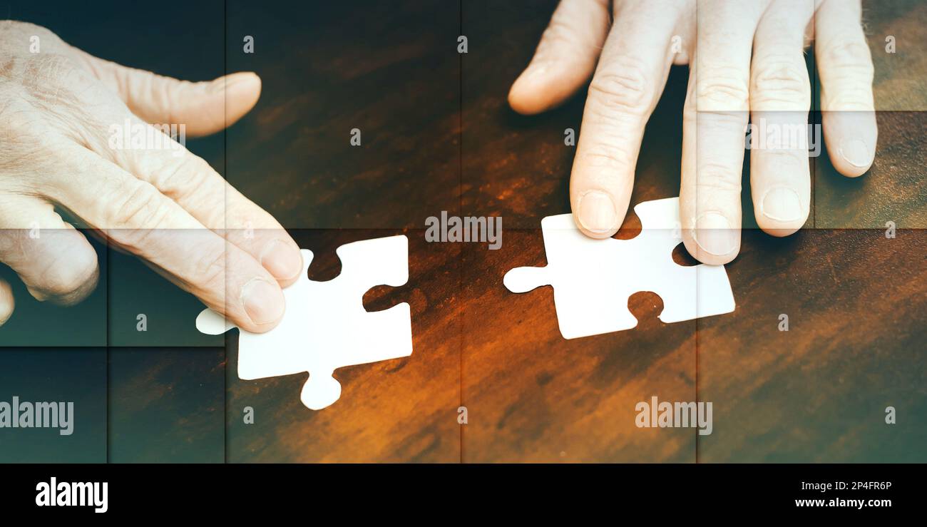 Hands joining two puzzle pieces, teamwork concept, geometric pattern ...