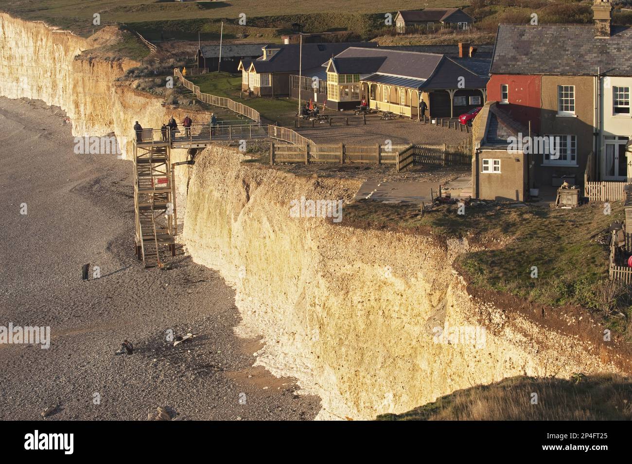 Coastal erosion, chalk cliffs with buildings on the edge, Birling Gap ...
