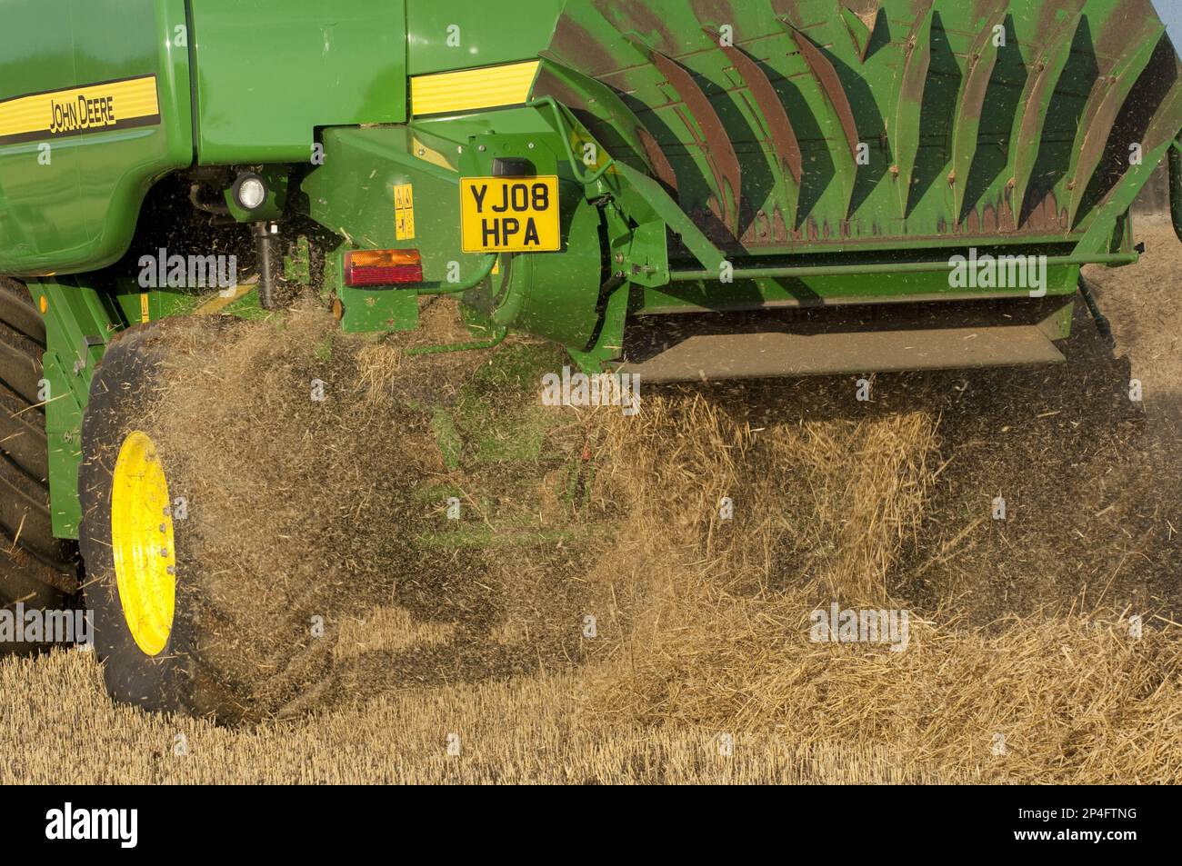 John Deere combine harvester, harvesting barley (Hordeum vulgare ...