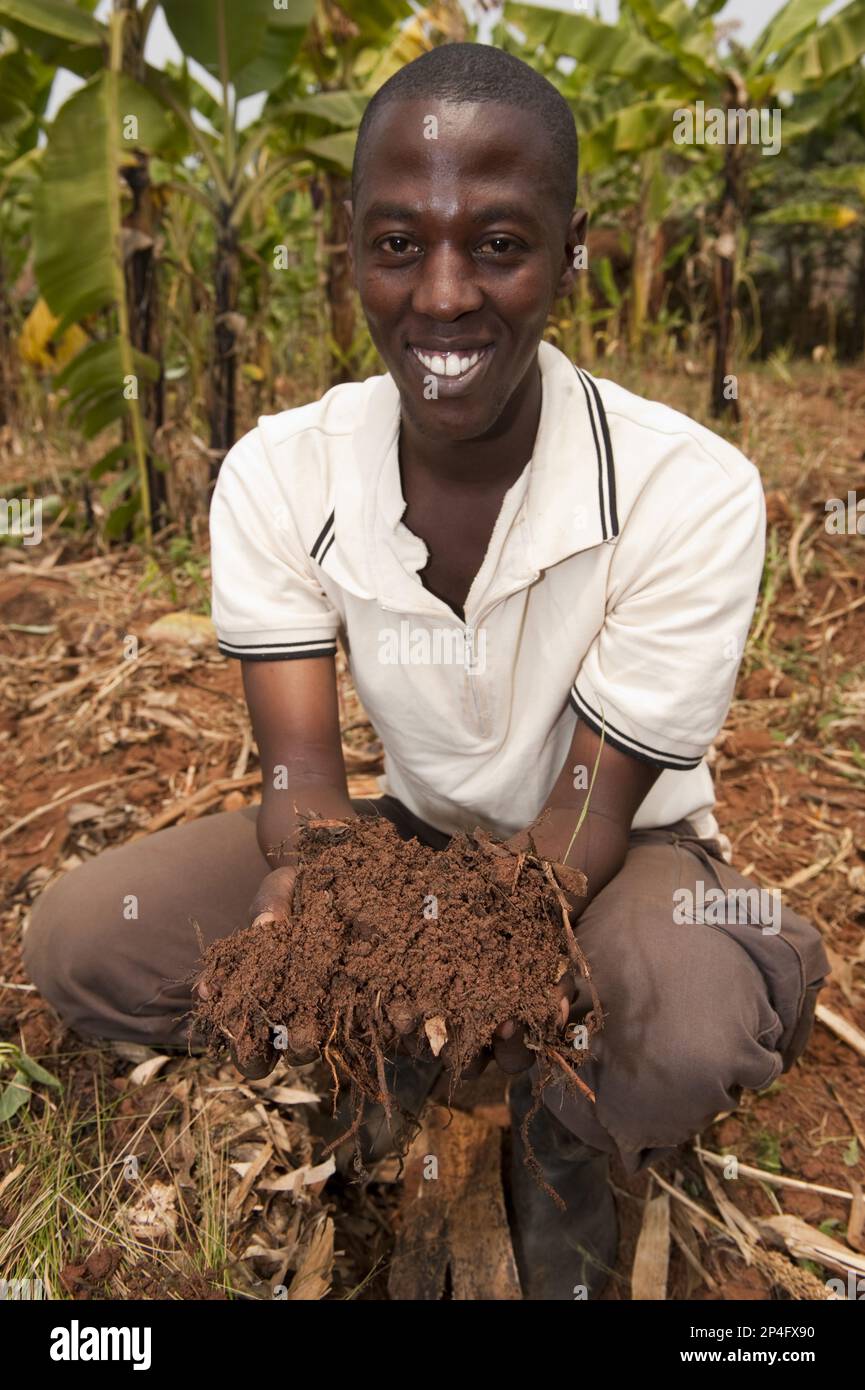 Farmer with fertile soil mixed with compost, Rwanda Stock Photo - Alamy