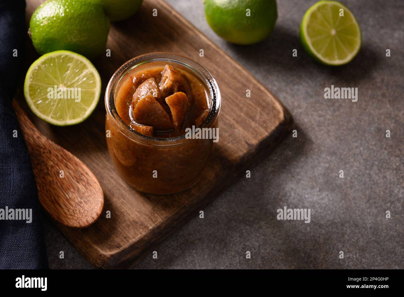 Home made Sri Lankan Lime Pickle of lime, salt, chilli, pepper on brown ...
