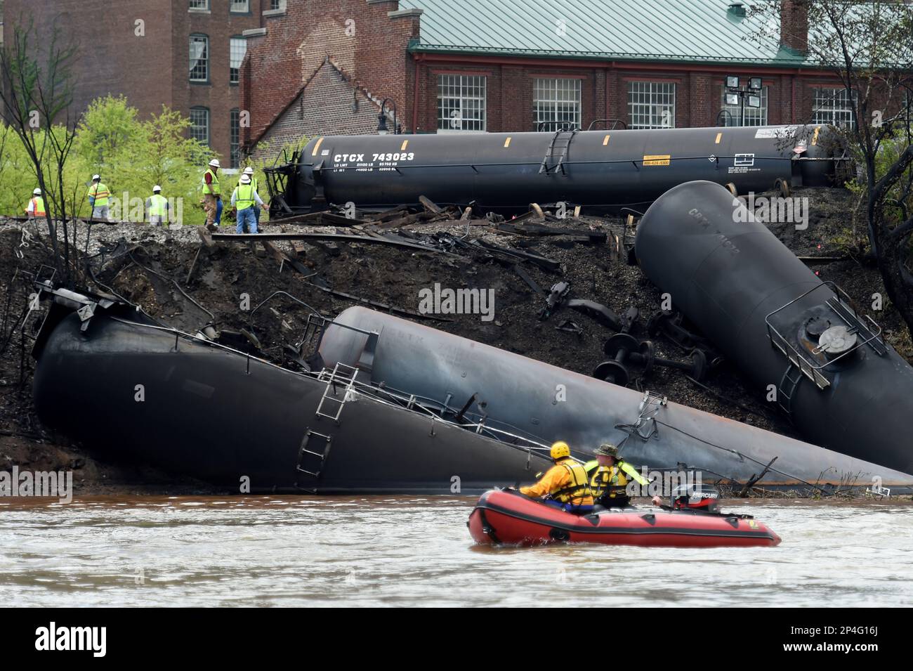 Workers prepare to begin pulling the first of three oil tanker train ...