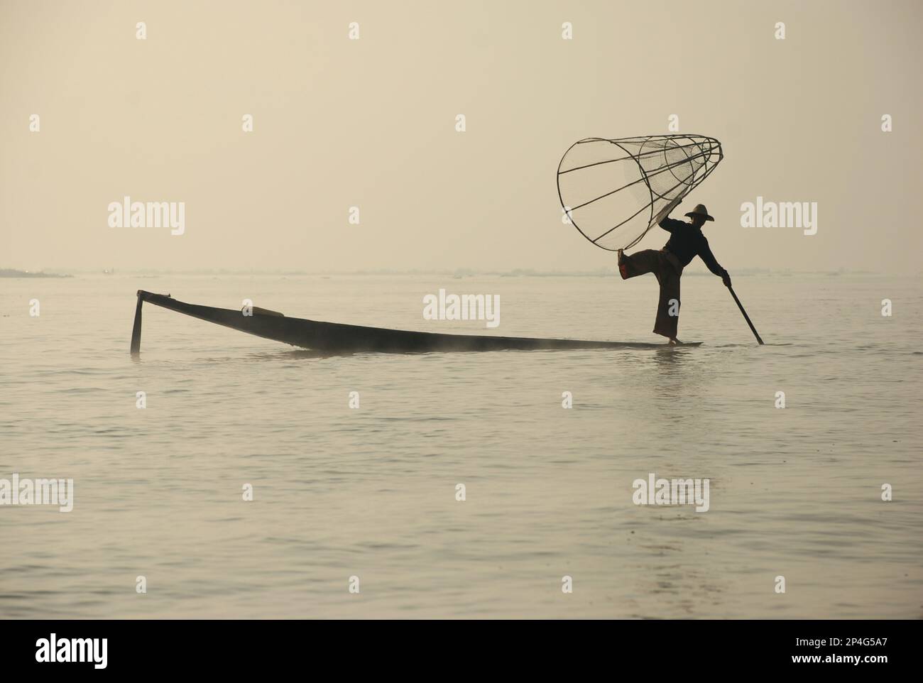 Traditional fisherman with fish trap in boat, Inle Lake, Shan State ...