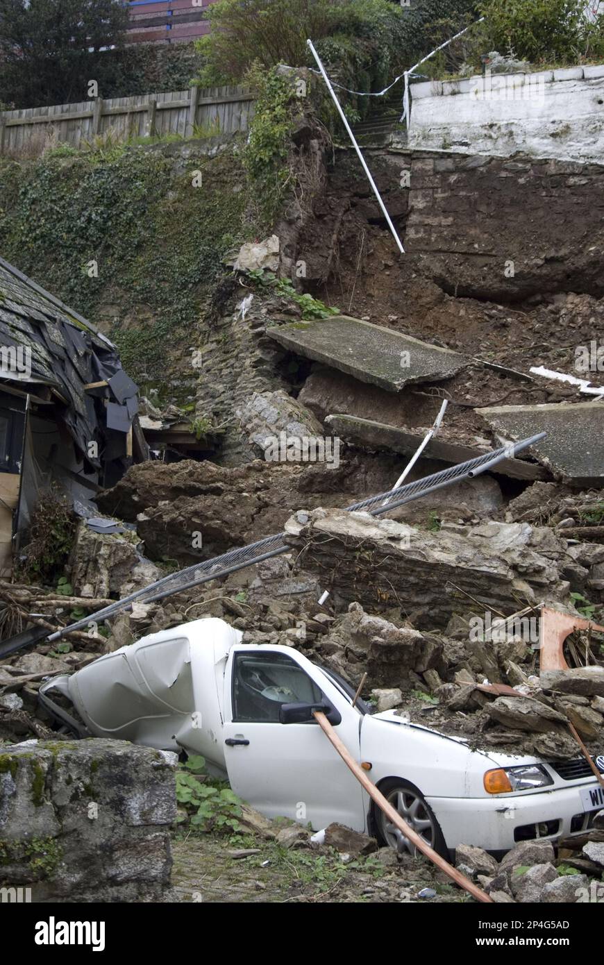 Landslide with van buried under debris in a coastal town, Quay Road ...