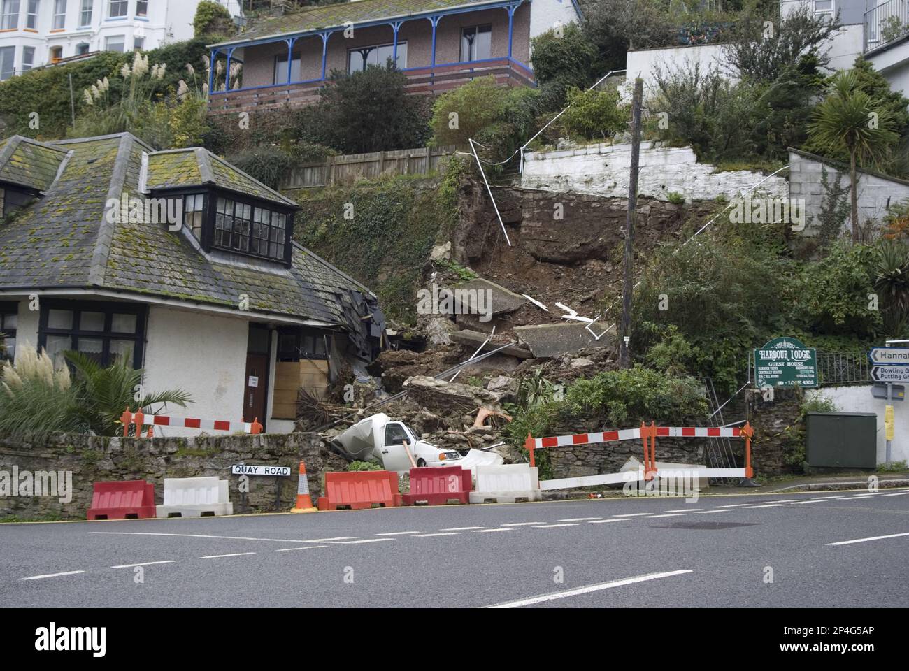 Landslide with van buried under debris in a coastal town, Quay Road ...