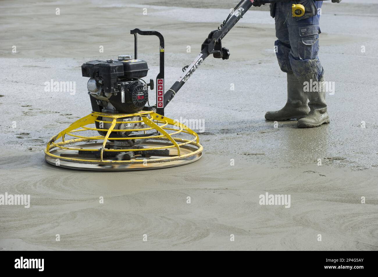 Construction work on farm building for loose housing, machine smoothing ...