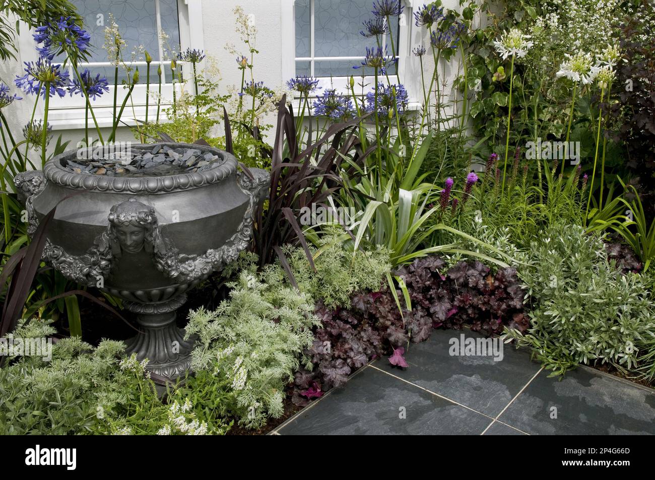 Large metal urn water feature and mixed patio planting, Norfolk ...
