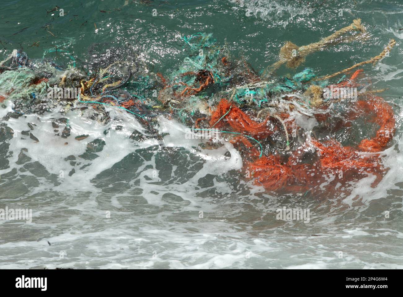 Large trawl net washing in from sea, Chesil Beach, Dorset, England ...
