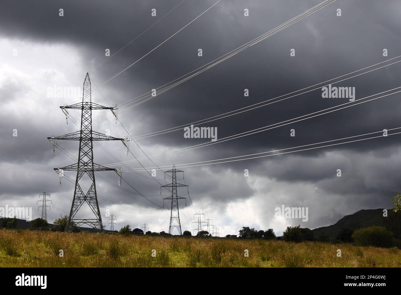 Power line pylons and storm clouds, over the Conwy Valley, Carneddau ...