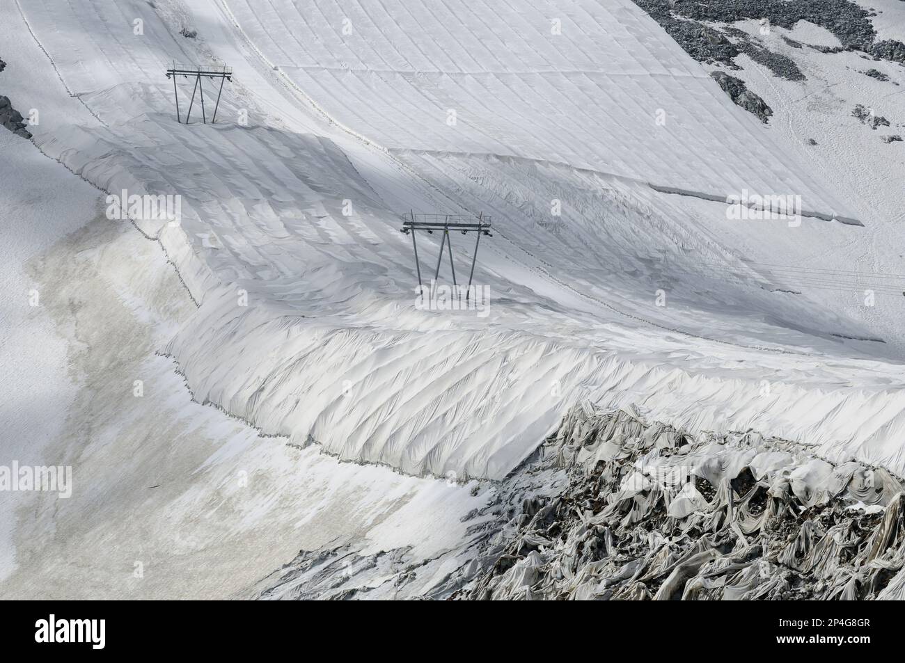 Textile protective covering to delay snow melt on ski slope with ski ...