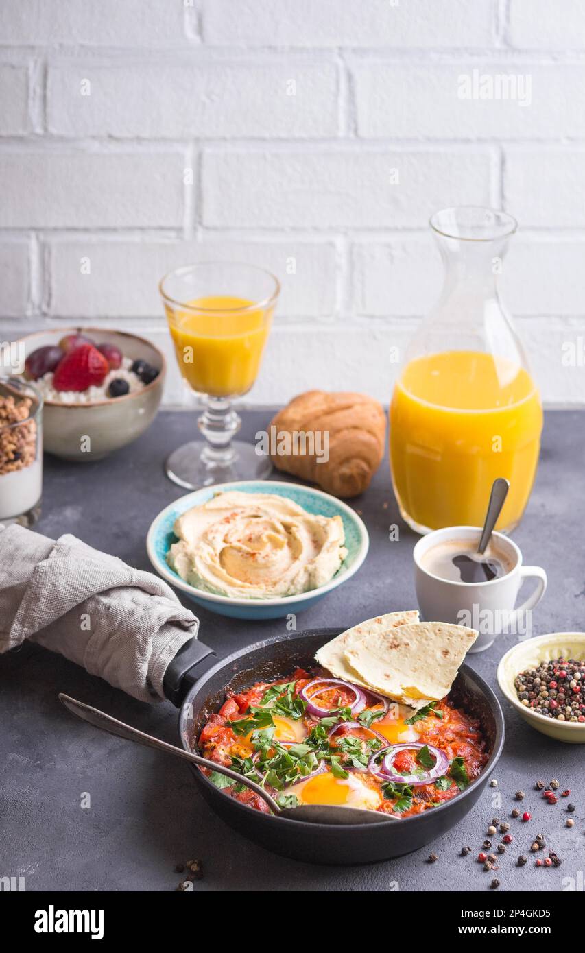Big healthy breakfast with middle eastern and european food. Shakshuka ...