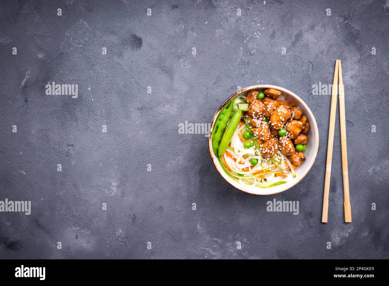 Asian style noodles with teriyaki chicken, vegetables and green peas ...