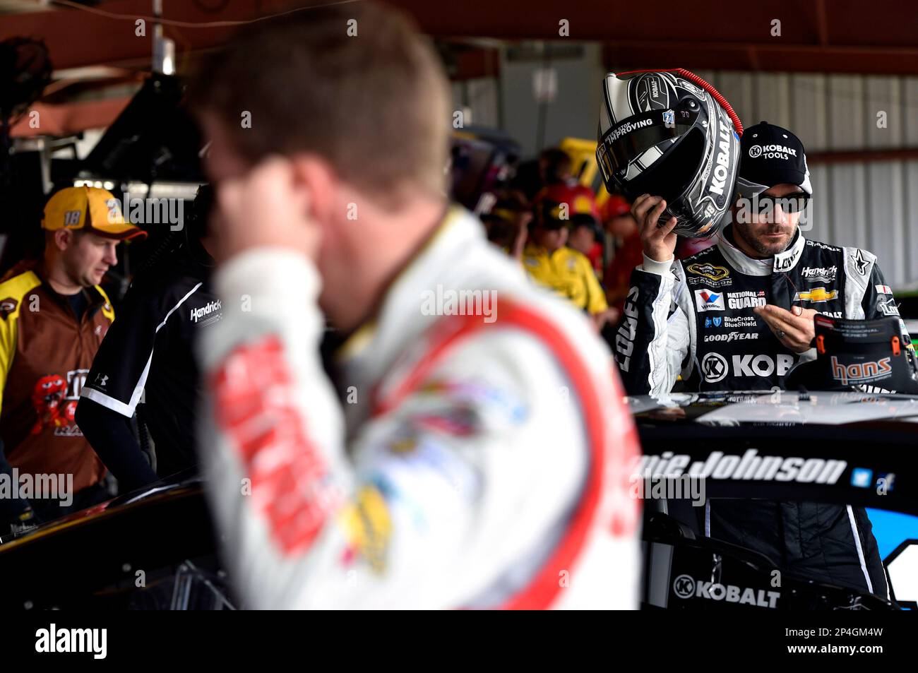 Dale Earnhardt Jr (left) and Jimmie Johnson (right) put their helmets ...