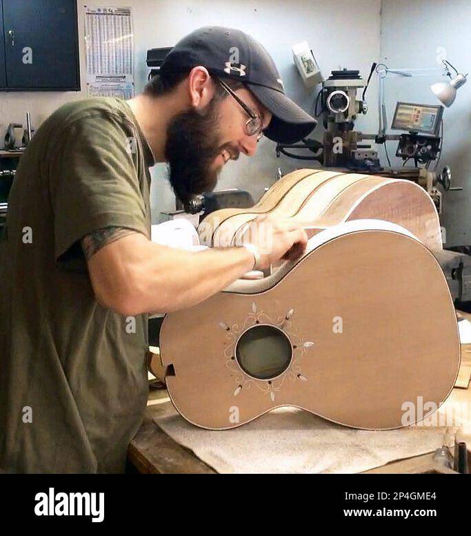 In this undated photo, Duane McGhghy sands a guitar at The Guitarsmiths ...