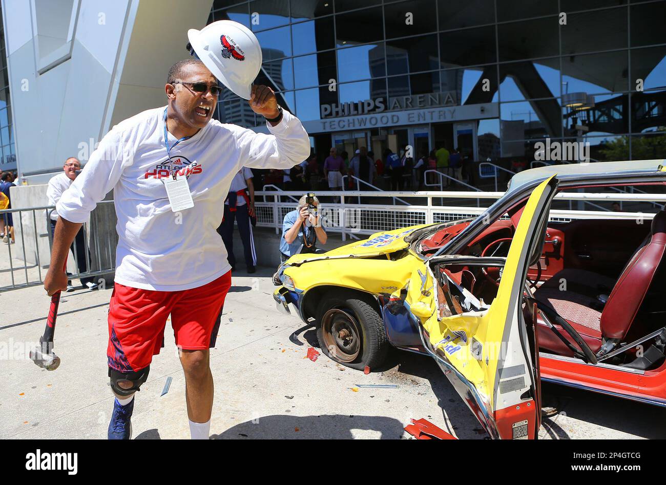 Steve Ware reacts after taking his turn swinging a sledge hammer to ...