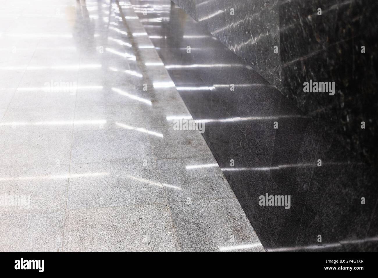 reflection of illumination in grey and black flooring tiles in ...