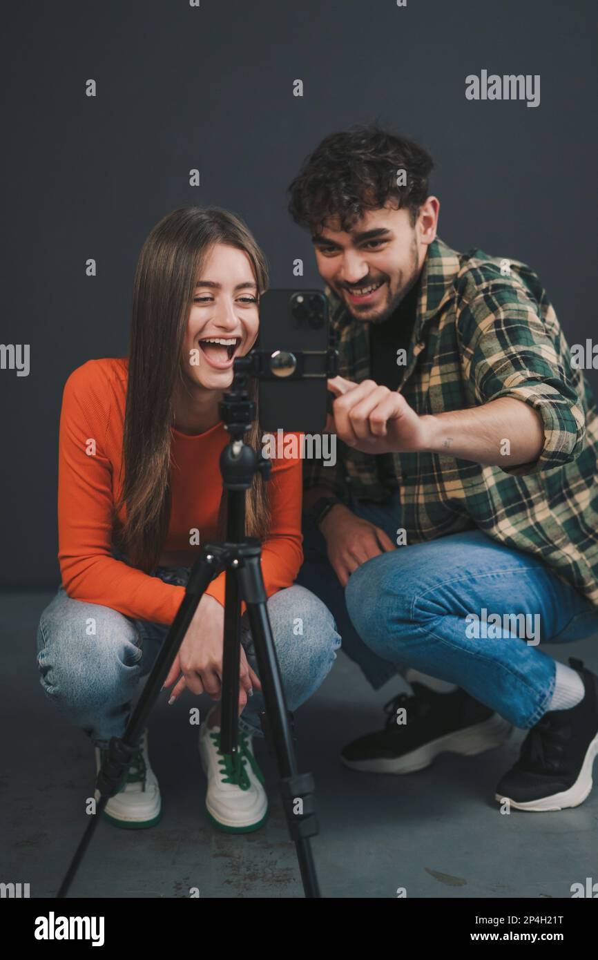 Two persons female and man bloggers leading live broadcast using a ...