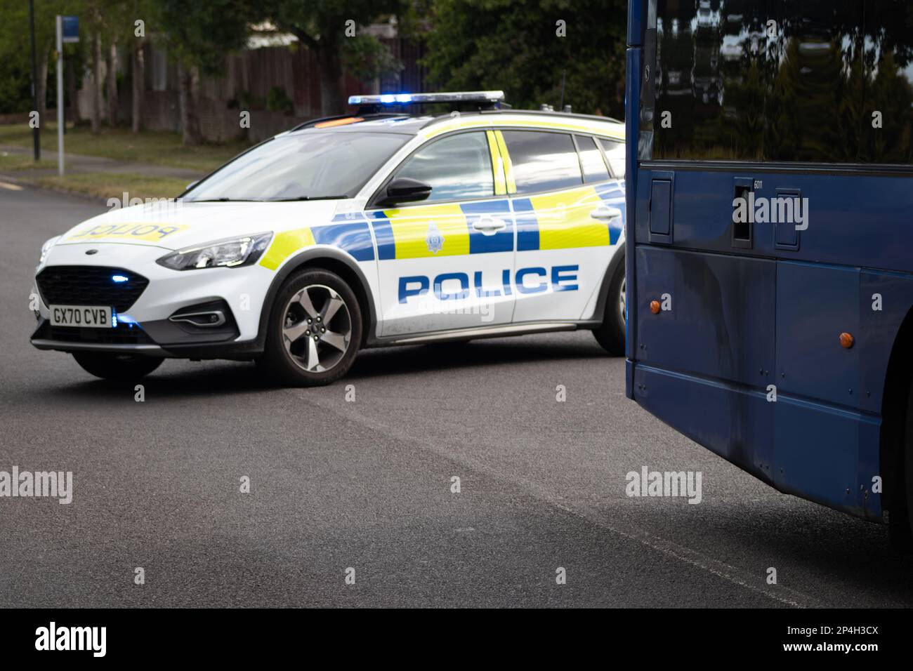 Police car blocking road behind bus Stock Photo - Alamy