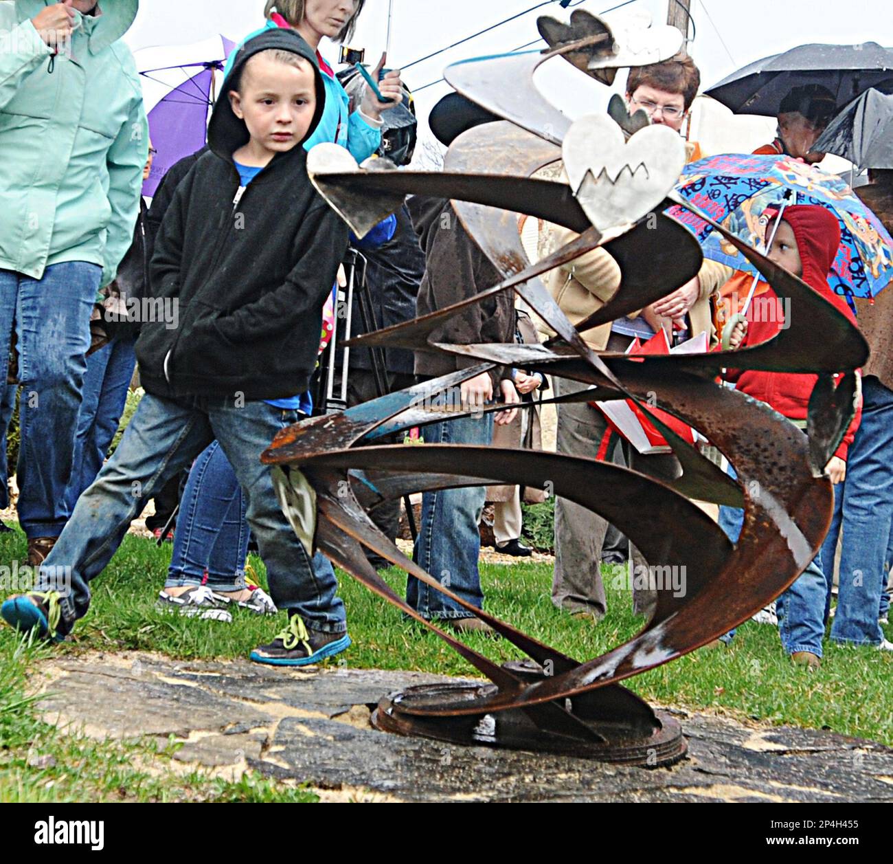 Amos Vincent of Leonore passes by the new spinning tornado sculpture ...