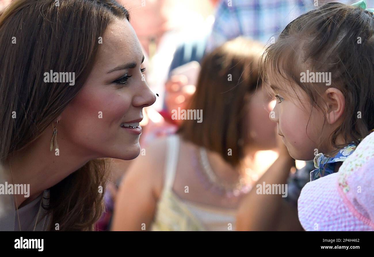 Britain's Kate, the Duchess of Cambridge, left, has a fly land on her ...