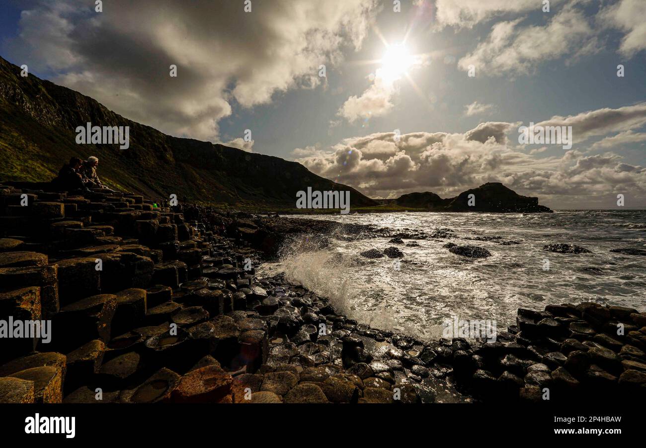 Couple watch the water in Ireland Stock Photo - Alamy