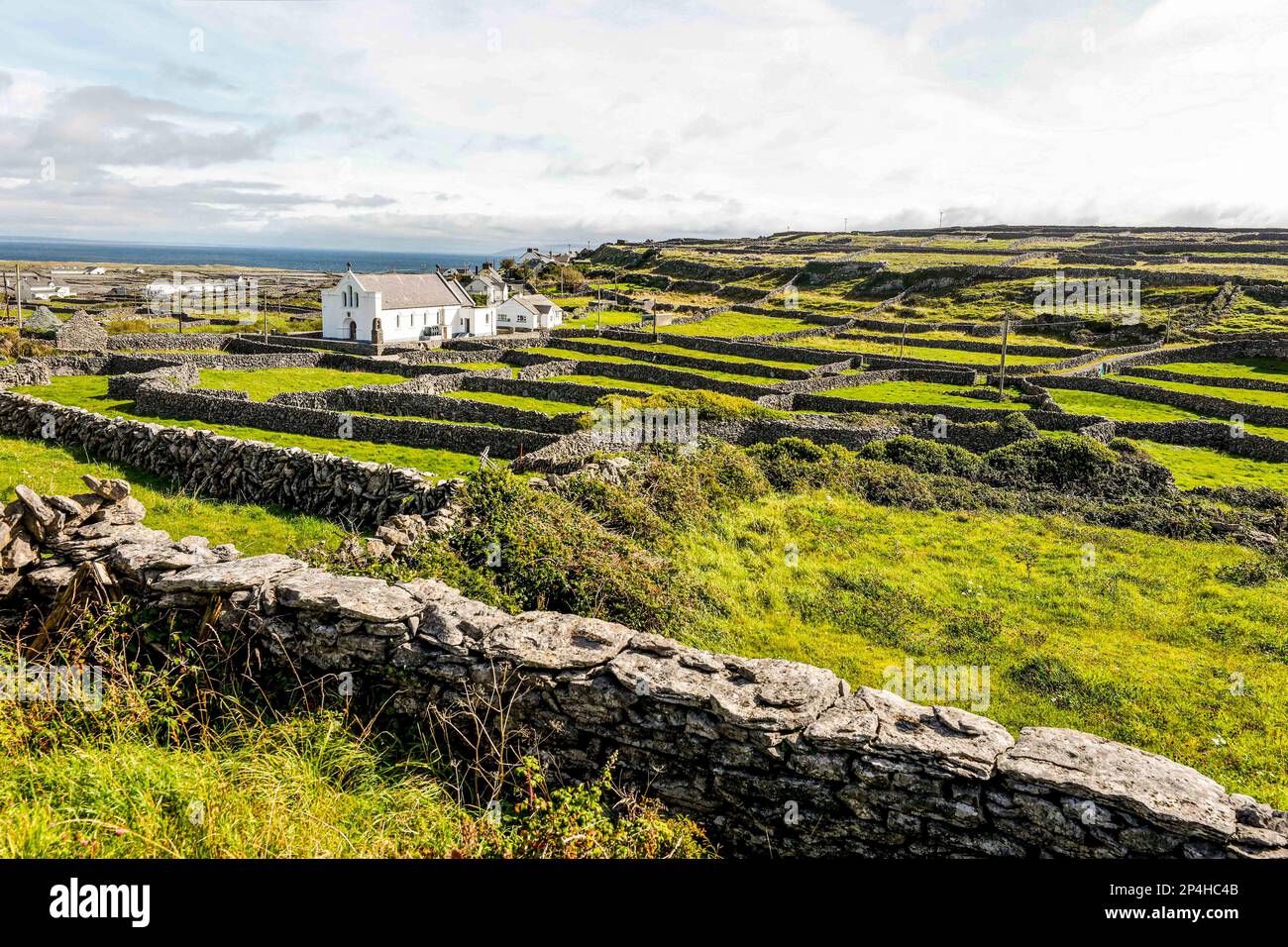 Church among stone walls of small island town of Ireland Stock Photo ...
