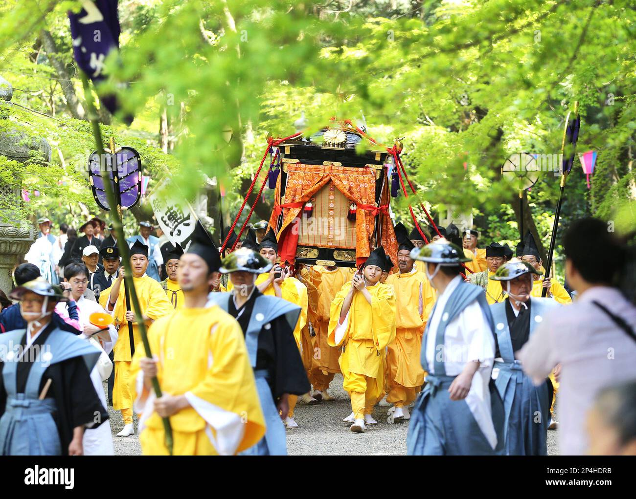 Shrine parishioner, wearing Heian period costumes, carry a portabl ...