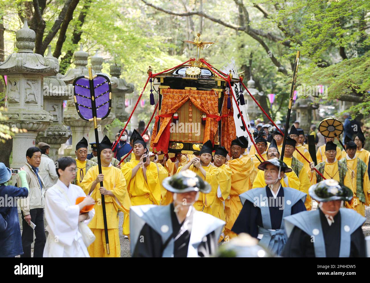 Shrine parishioner, wearing Heian period costumes, carry a portabl ...