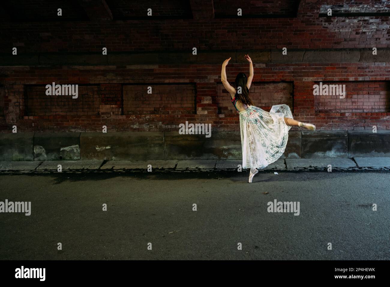 ballerina dancing under bridge outside Stock Photo - Alamy