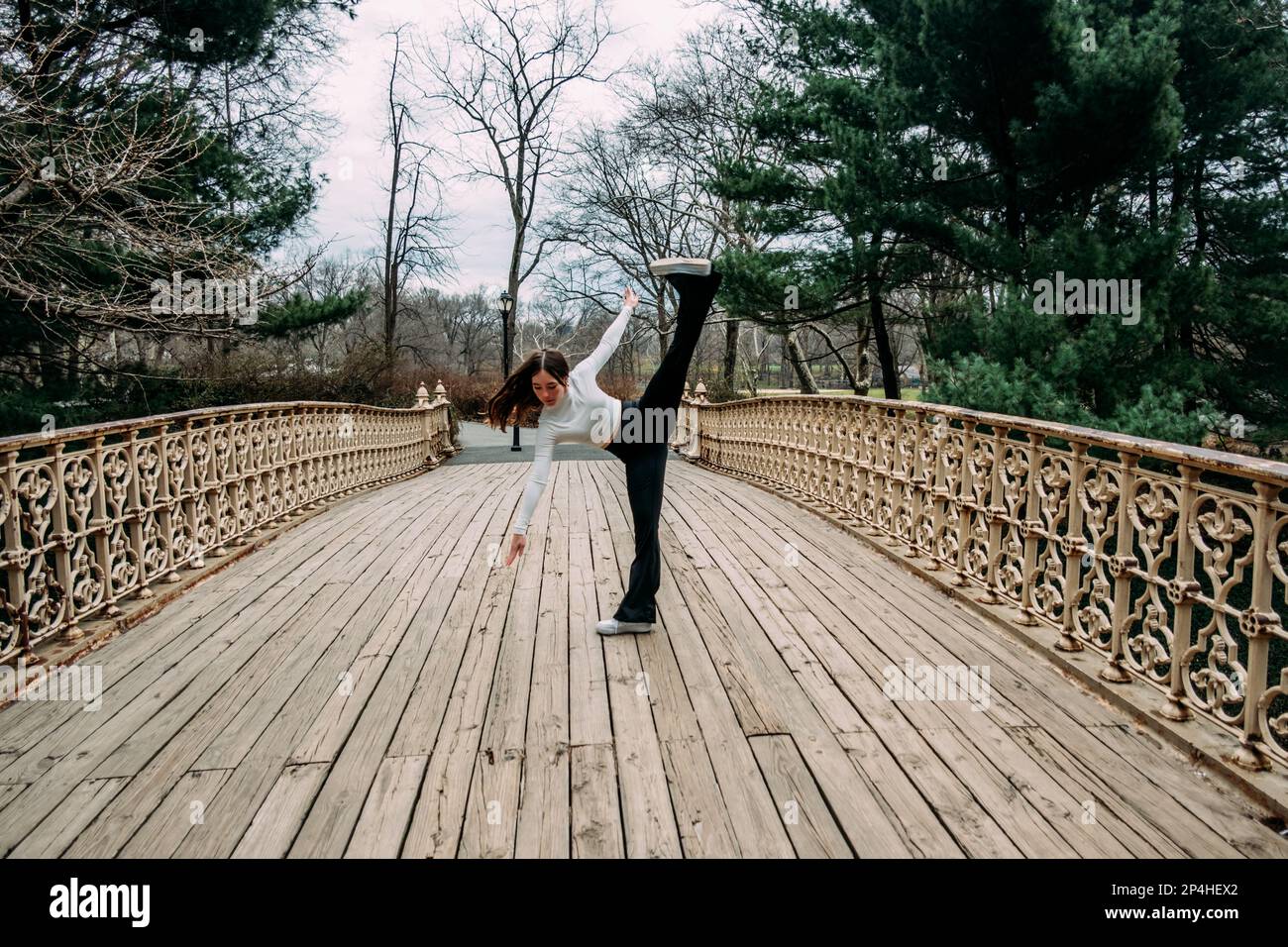 Teen girl dancing on bridge outside Stock Photo - Alamy