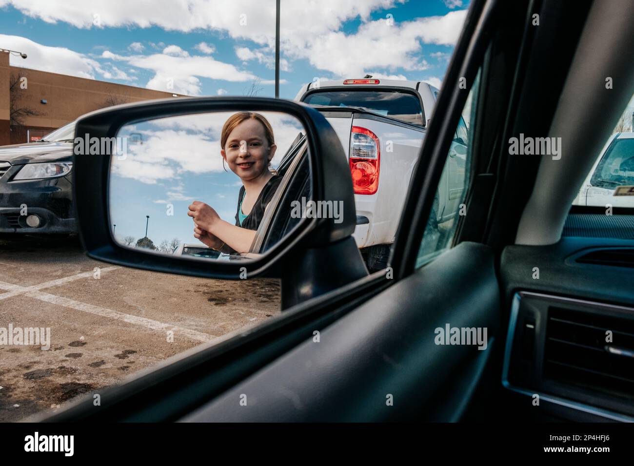 Reflection of young girl looking out of car window Stock Photo - Alamy