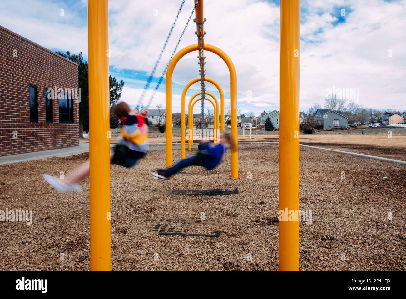 Two children on swings hi-res stock photography and images - Alamy