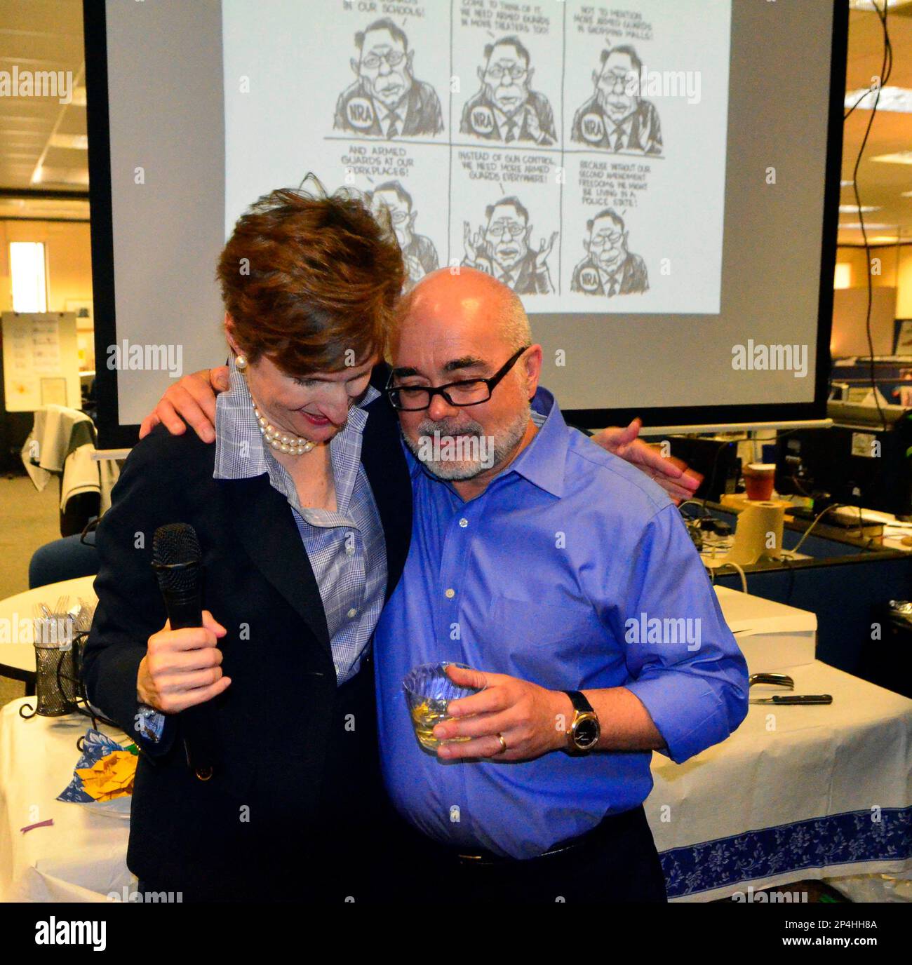 Charlotte Observer Publisher Ann Caulkins, left, gives a hug to ...