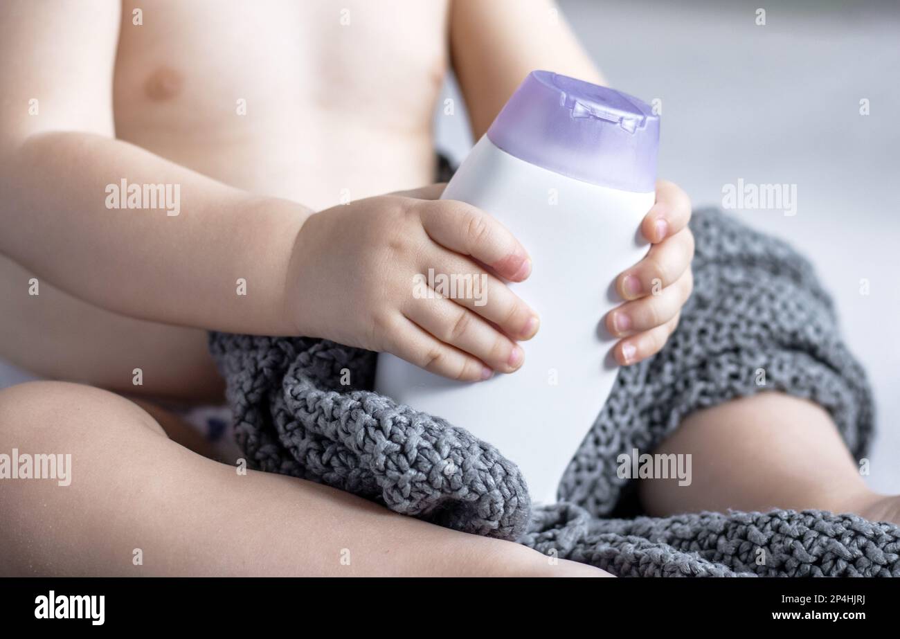 baby holding shampoo shower gel bottle soft toy teddy bear Stock Photo ...