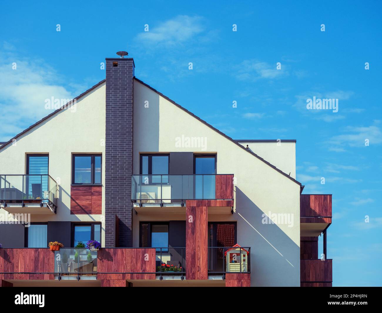 front view of modern new apartment house over blue sky background ...