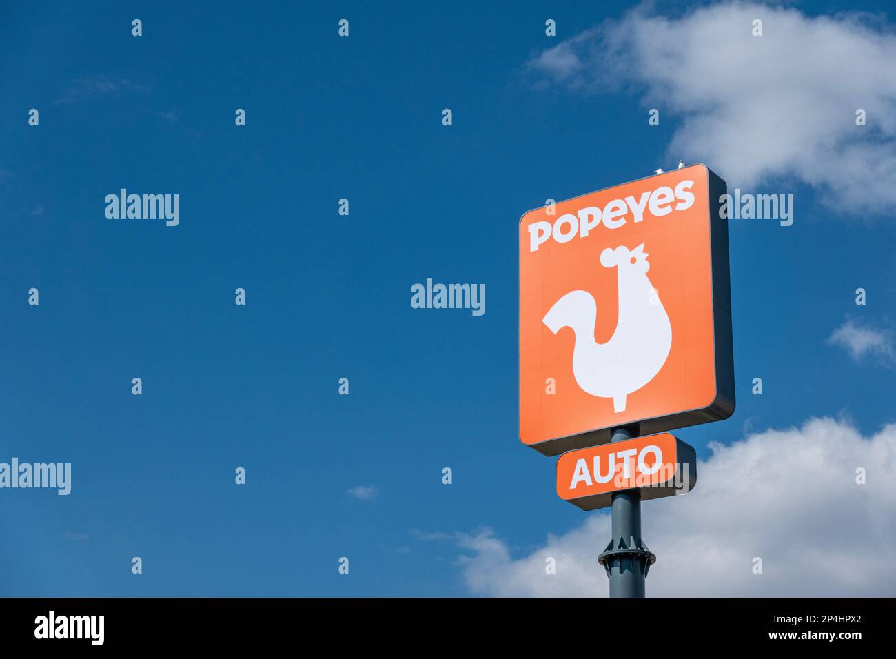Finestrat, Spain - March 2, 2023: Popeyes logo sign on pole with blue ...