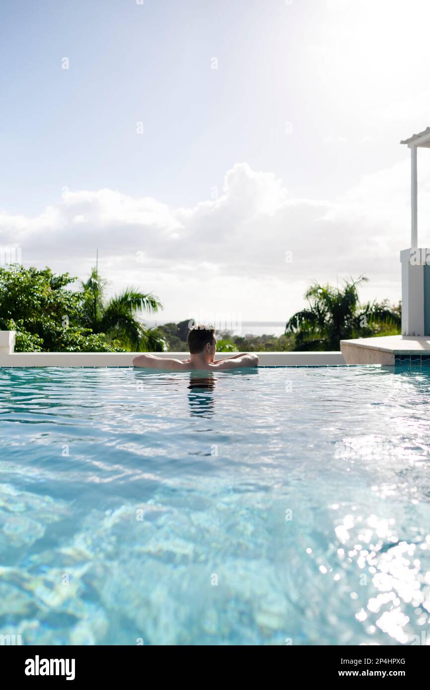 Solo man enjoying the pool on a sunny day in Puerto Rico Stock Photo ...