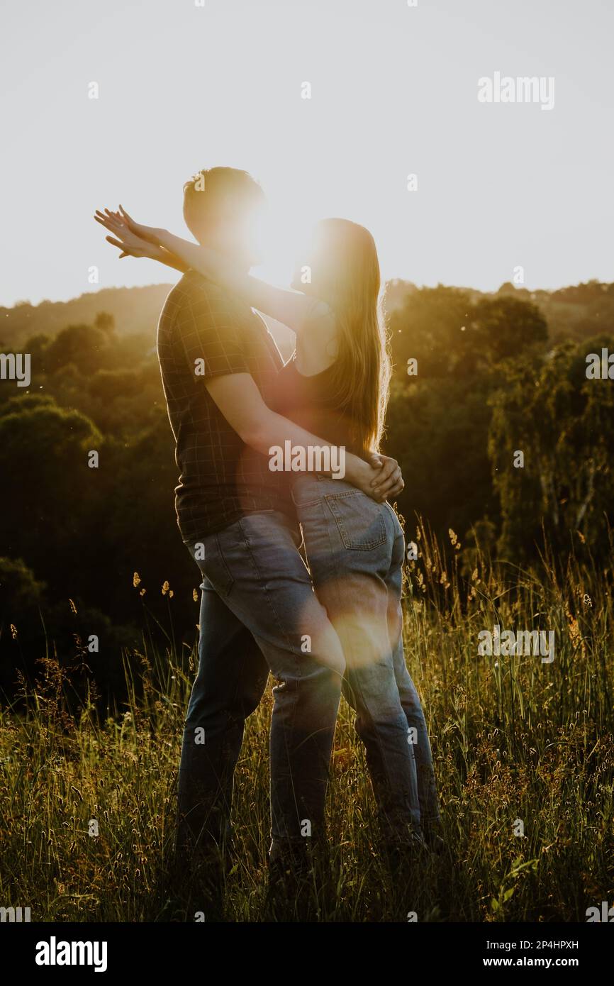 man and a woman hug in the park against sun in summer Stock Photo - Alamy