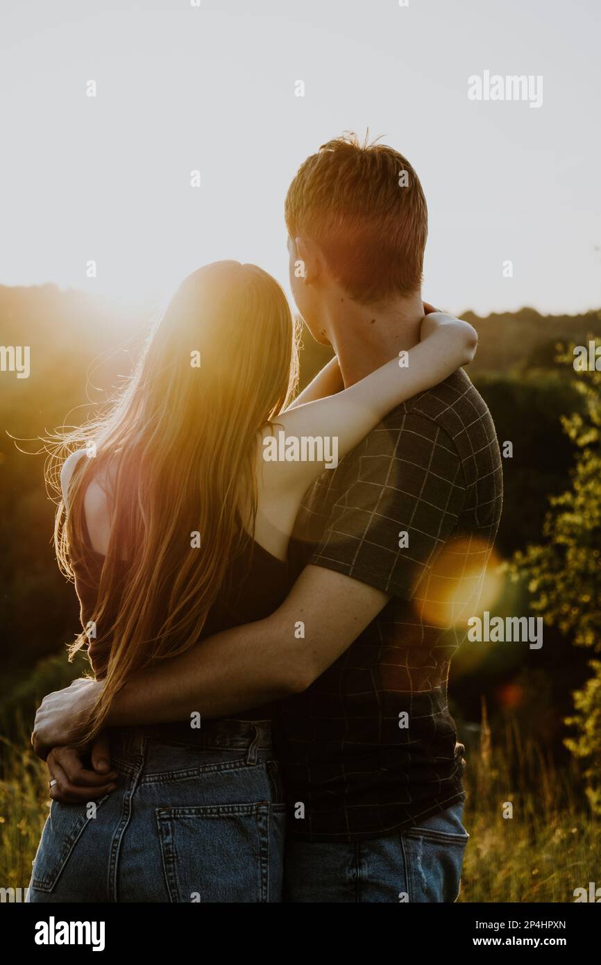 man and a woman hug in the park against sun in summer Stock Photo - Alamy