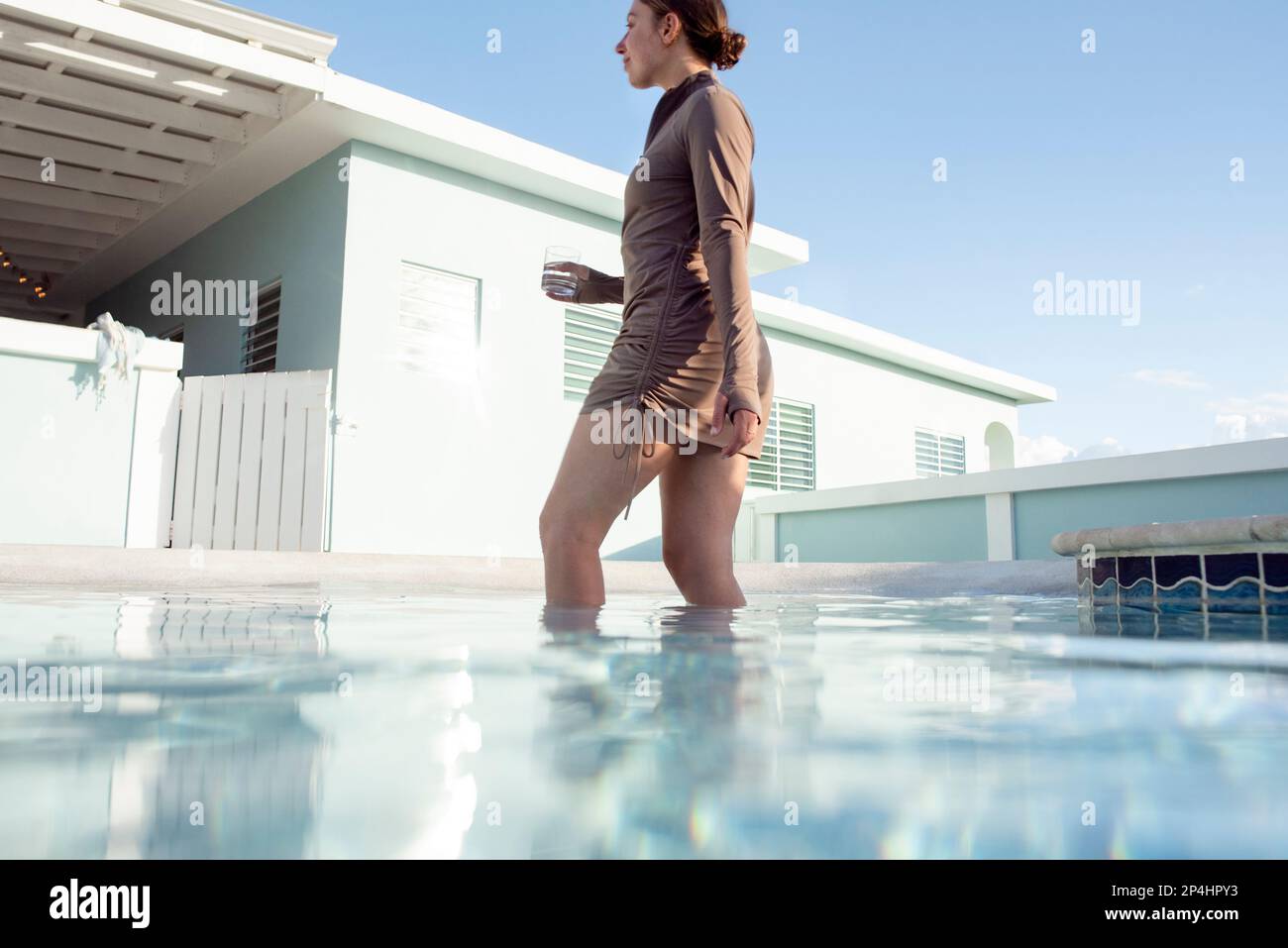 Solo woman with drink enjoying a dip in the pool in Puerto Rico Stock ...