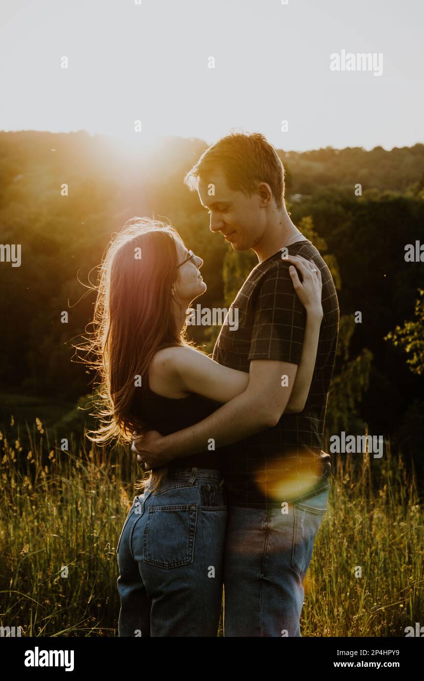 man and a woman hug in the park against sun in summer Stock Photo - Alamy