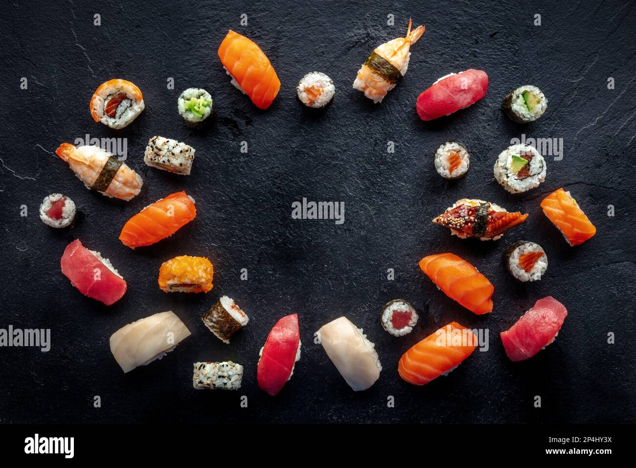 Sushi frame, overhead flat lay shot. Rolls, maki, nigiri on a black ...