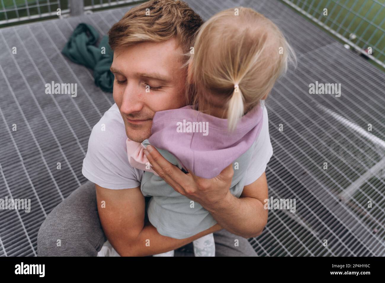 Dad and baby daughter have fun near the football field stadium Stock ...