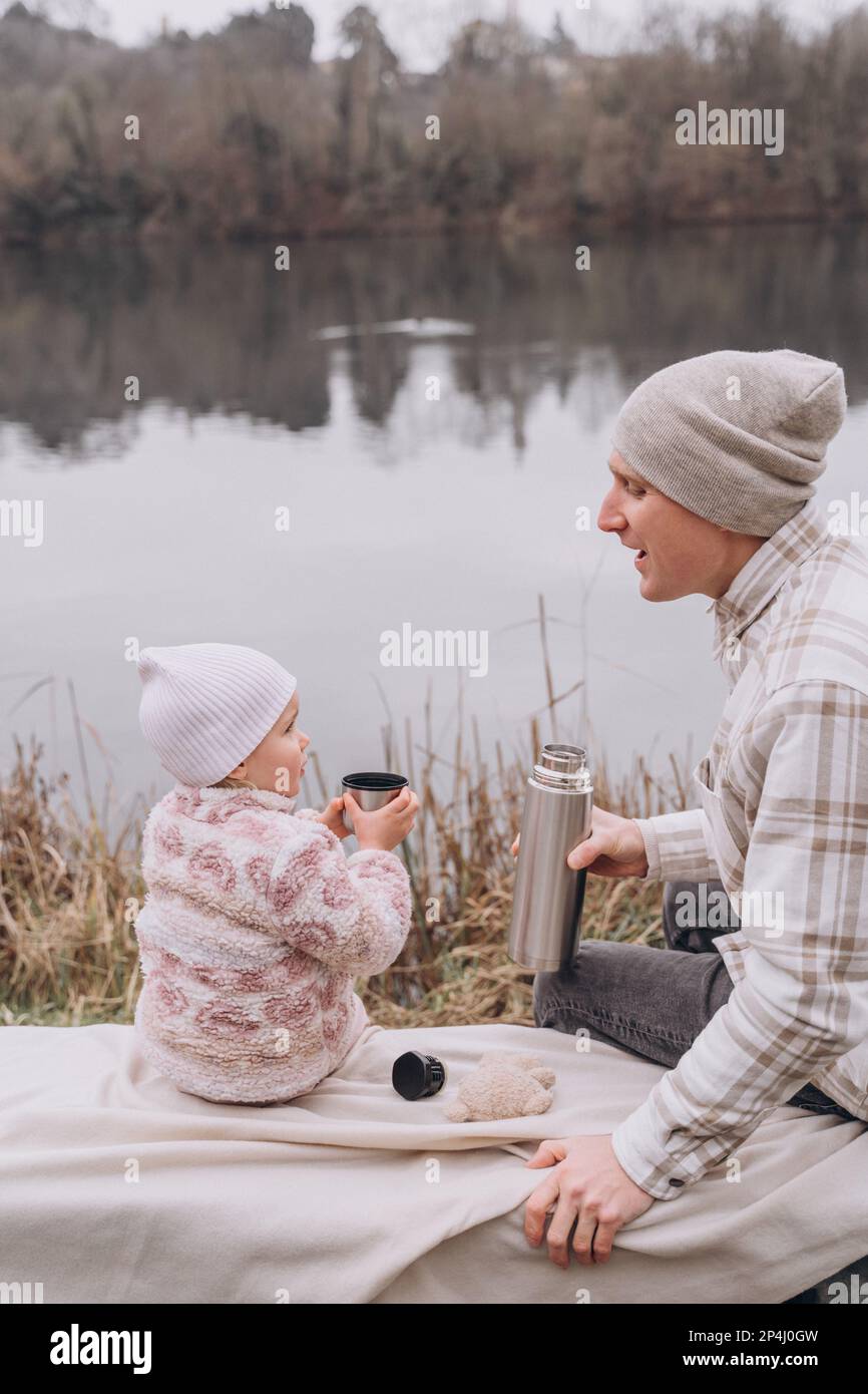 Picnic with dad in the park in early spring Stock Photo - Alamy