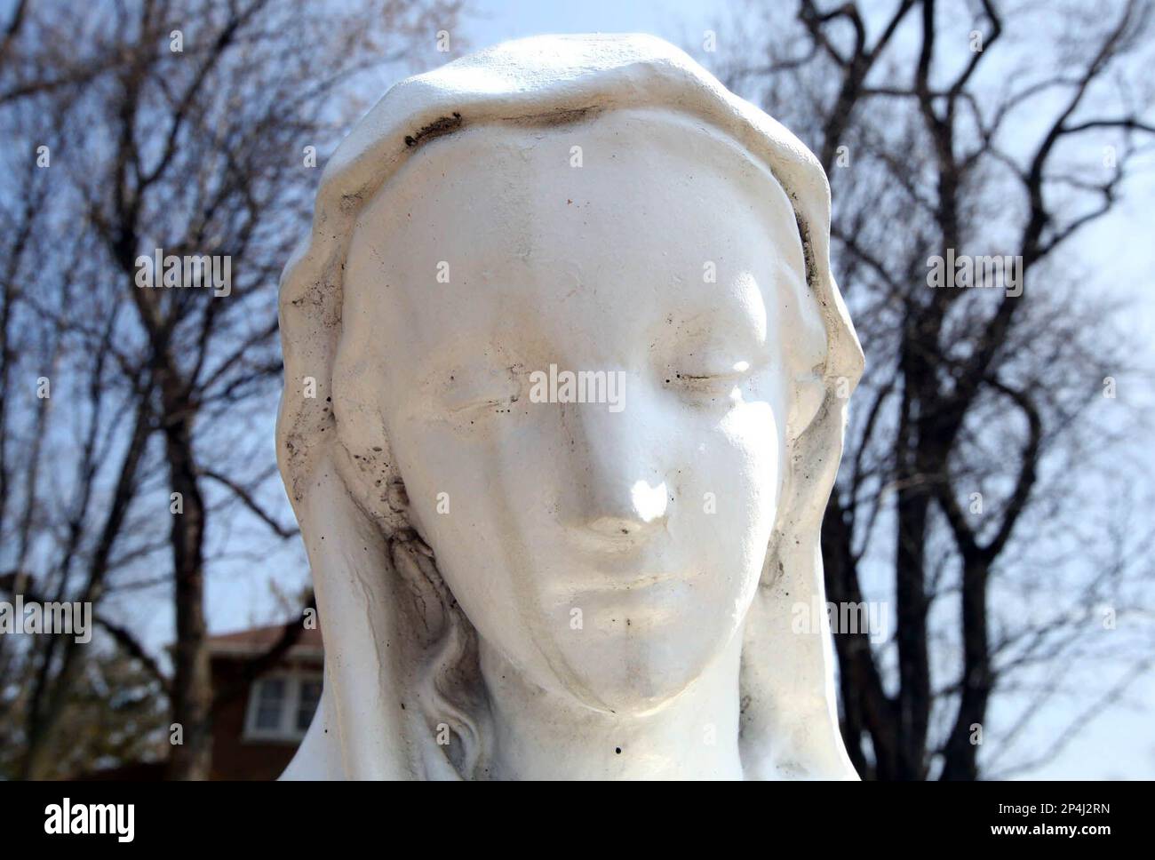 A water stain runs down the right check on a statue of Mary at St. Mary ...