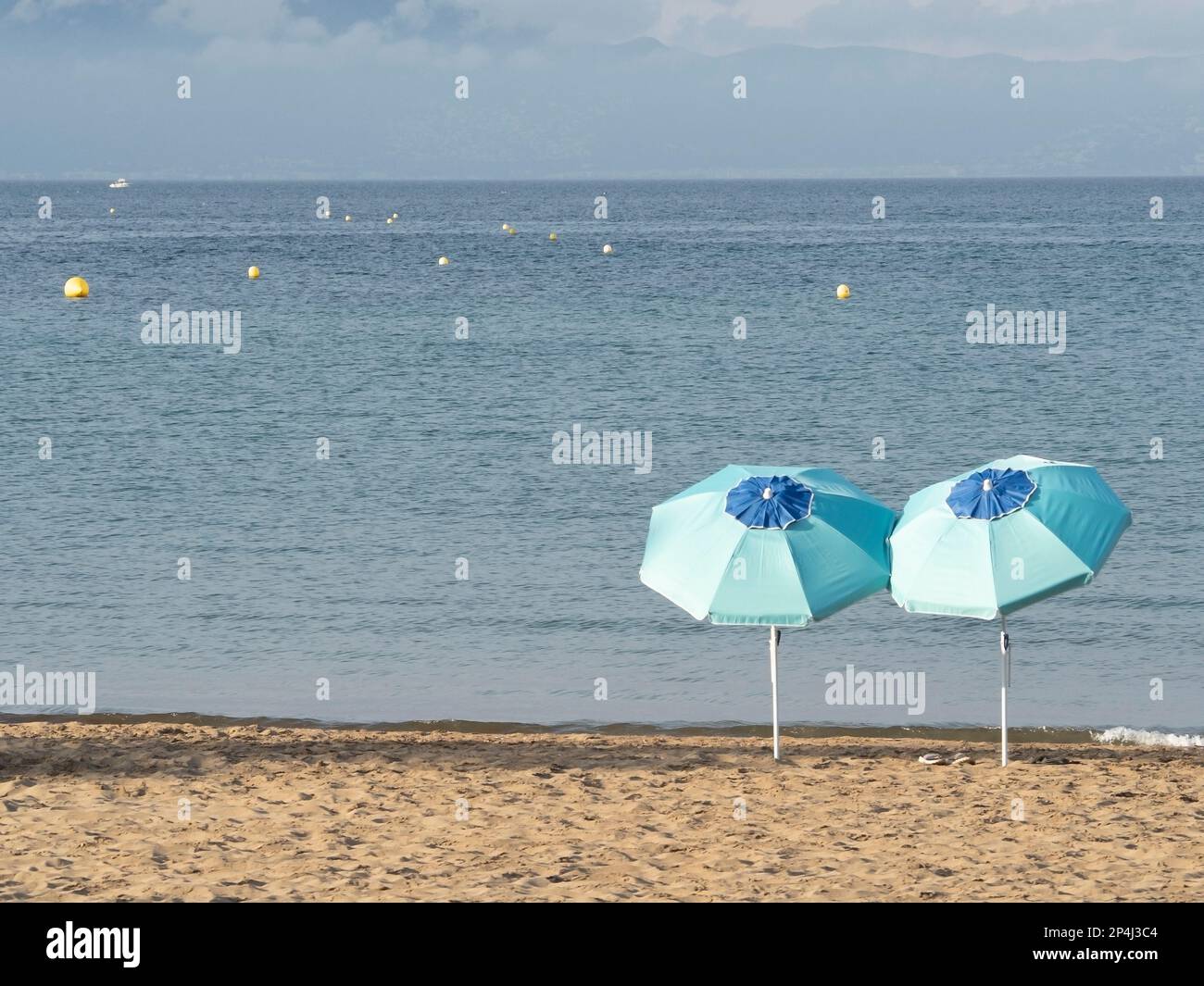 Blue umbrellas on the beach hi-res stock photography and images - Alamy