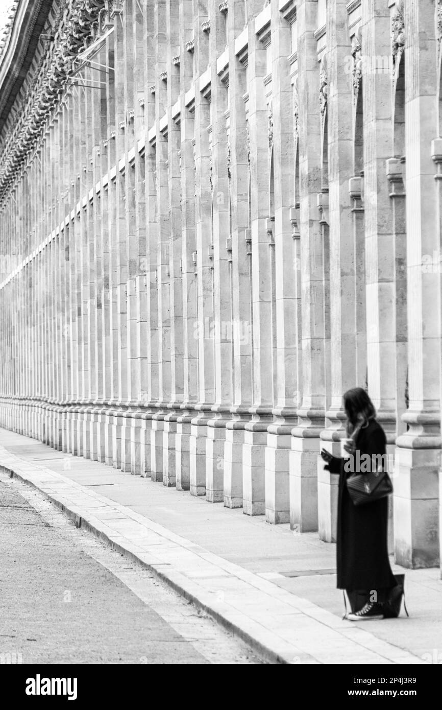 Black and White Photo of a lone women standing against a backdrop of ...