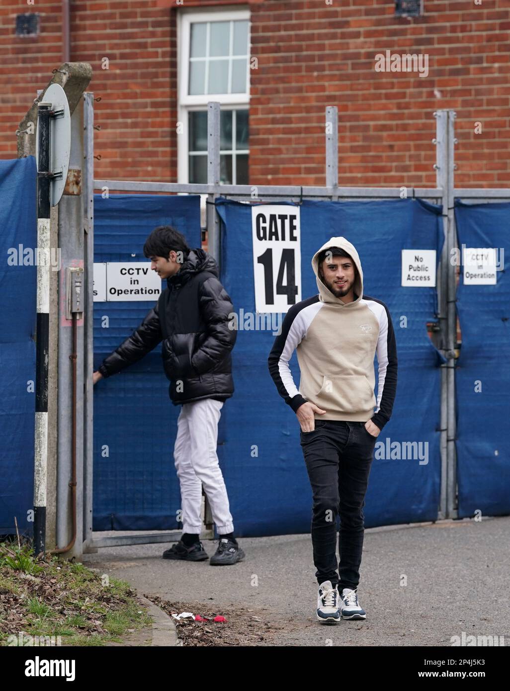 Migrants housed at Napier Barracks in Folkestone, Kent, leave through ...